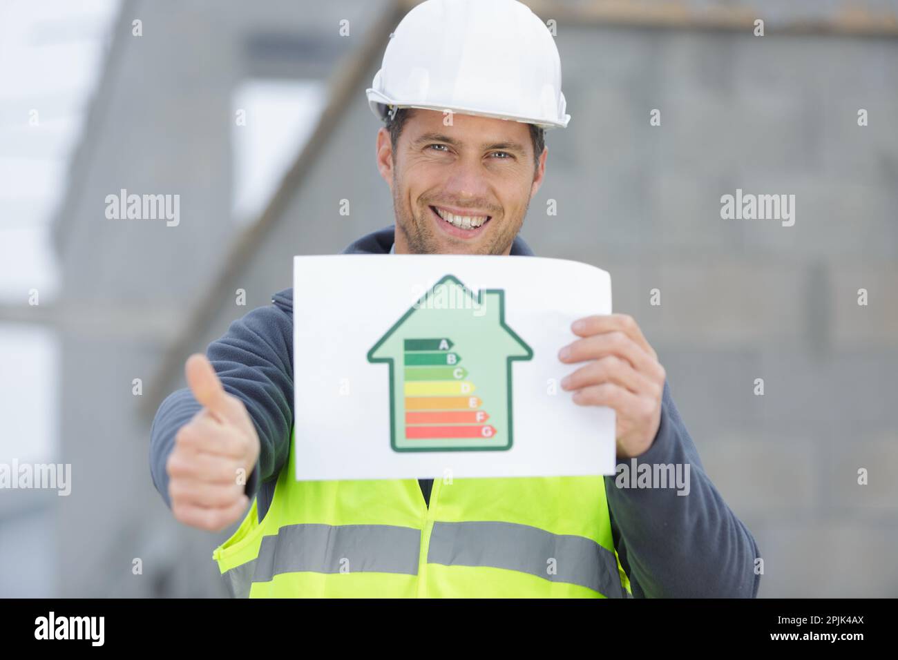 happy builder showing a paper chart Stock Photo - Alamy
