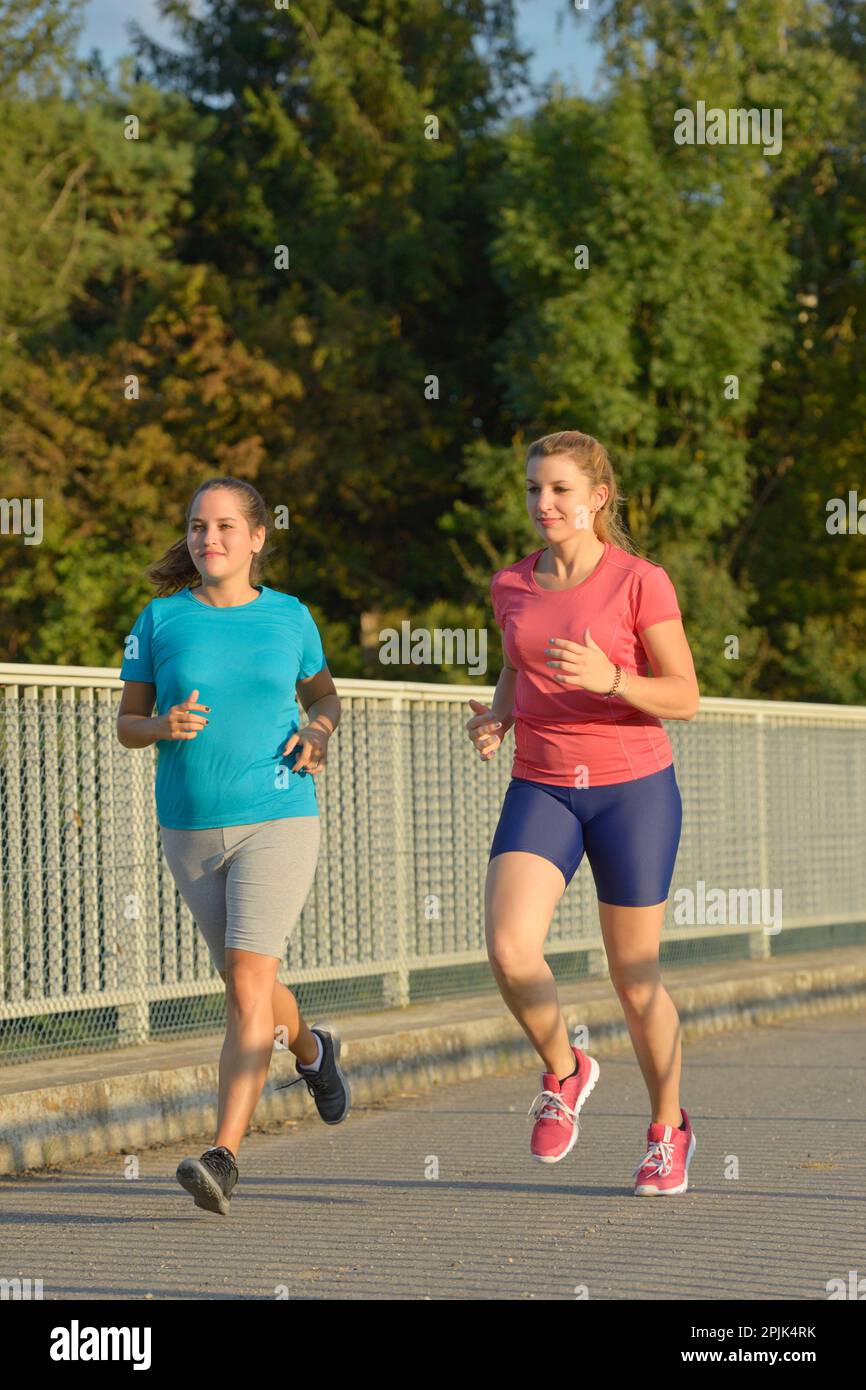 Two running women hi-res stock photography and images - Alamy