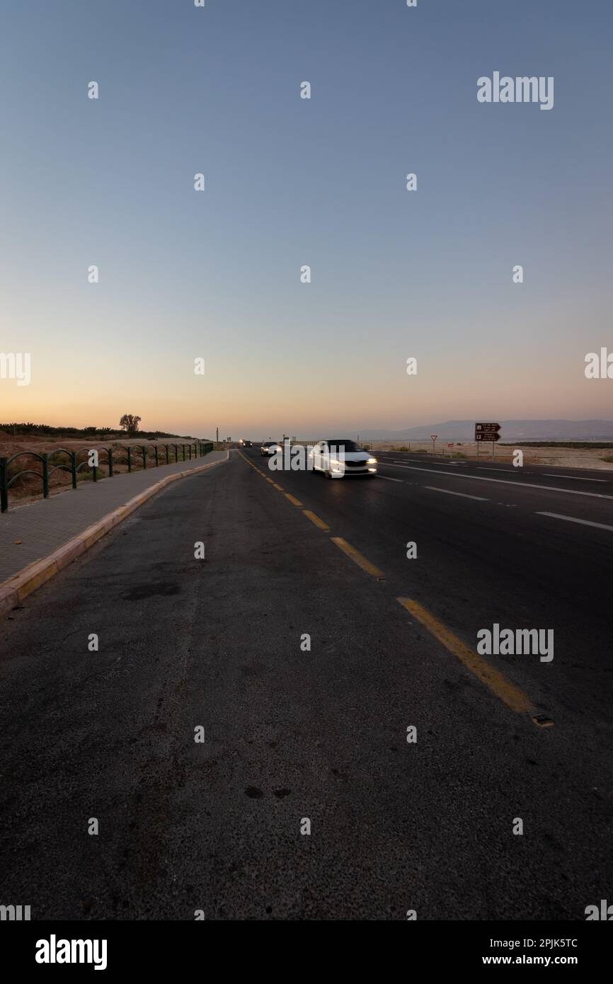 A vehicle traveling on Route 90 near the Jordan River - Israel - sunset ...
