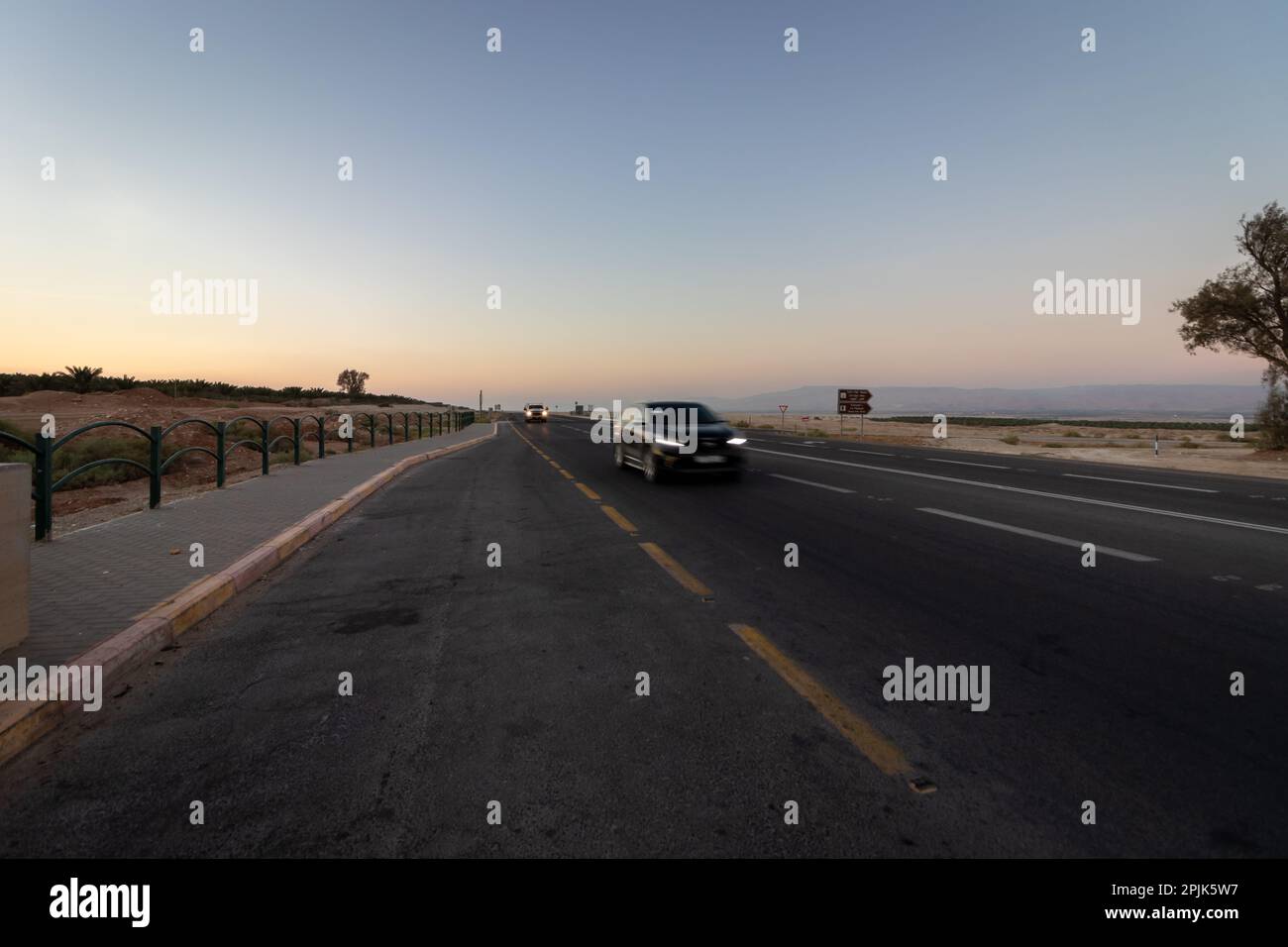 A vehicle traveling on Route 90 near the Jordan River - Israel - sunset ...