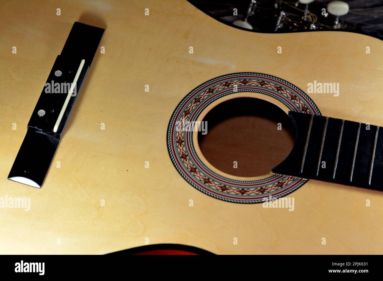 A broken wooden old classic guitar with damaged strings chords ...