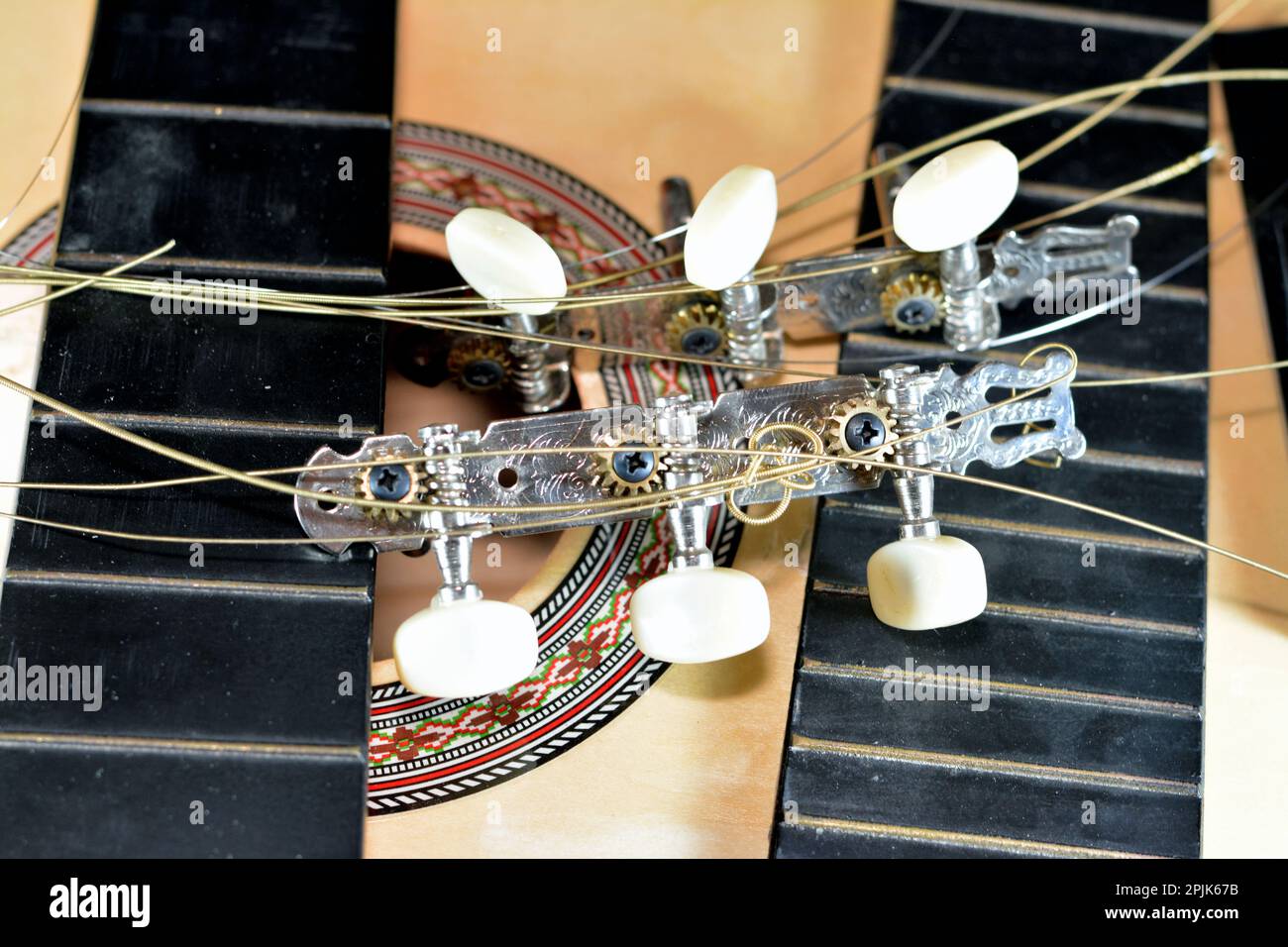 A broken wooden old classic guitar with damaged strings chords ...