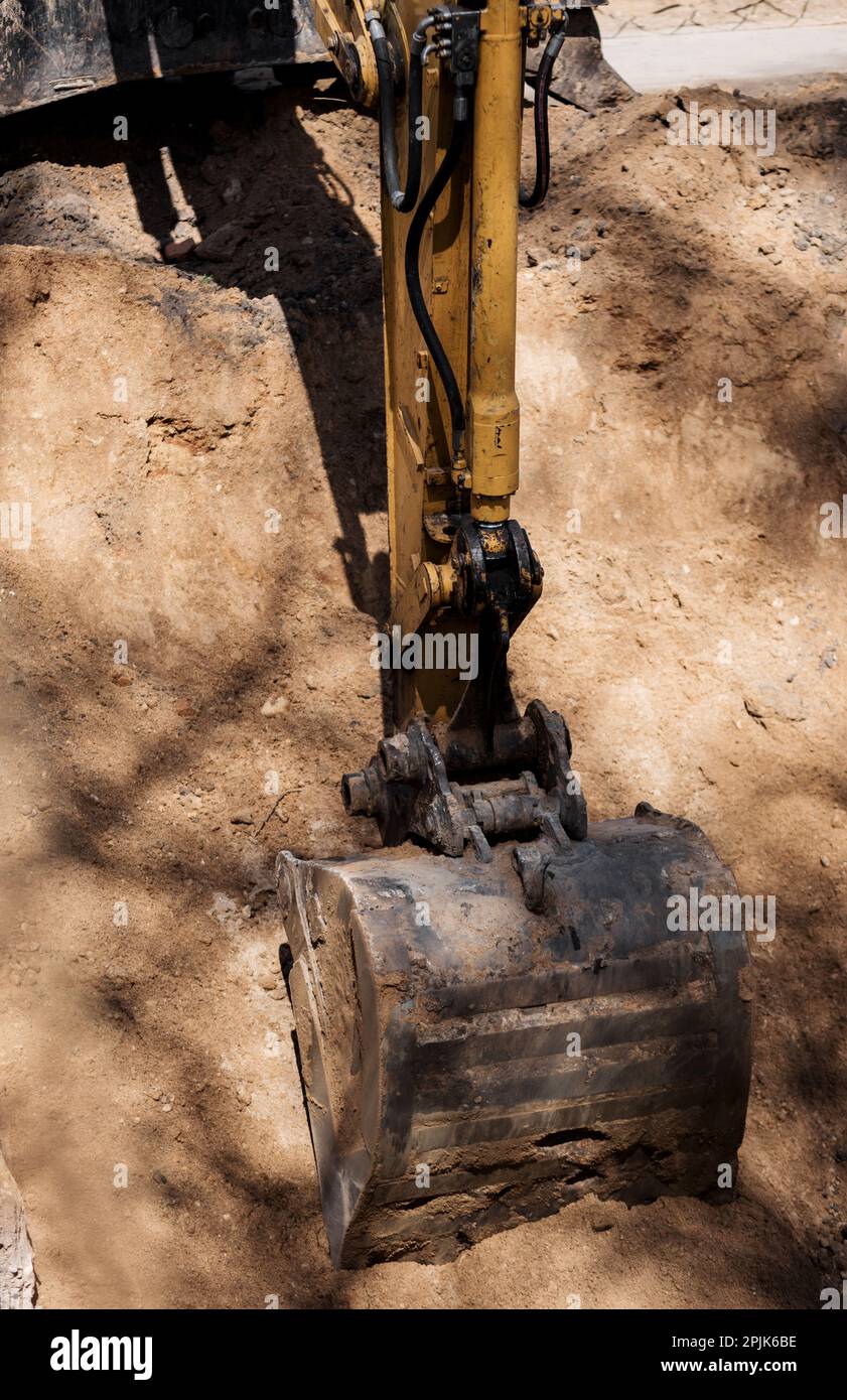 metal bucket teeth of backhoe digging soil. industrial concept Stock ...