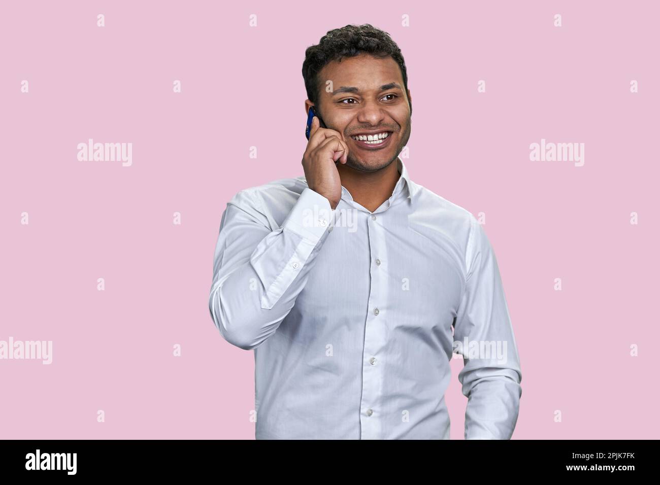 Positive indian businessman is having a phone conversation. Brown man ...