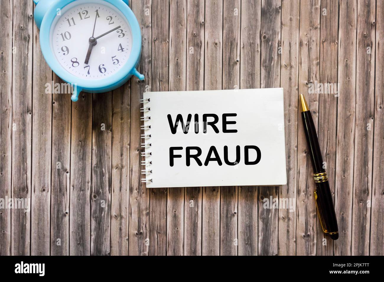 WIRE FRAUD text with clock, pen on wooden background, business Stock ...