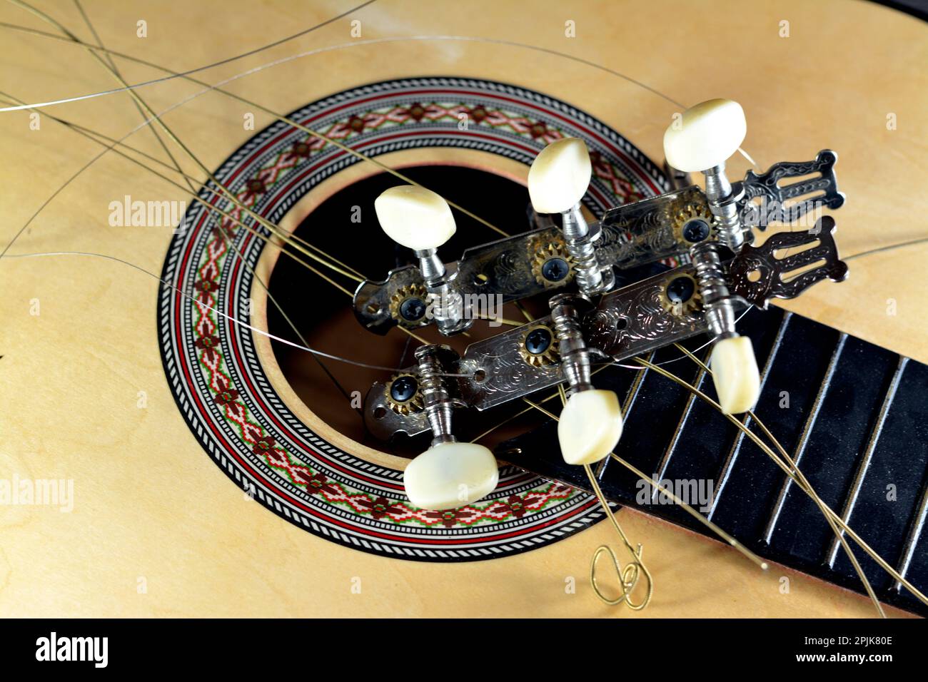 A broken wooden old classic guitar with damaged strings chords ...