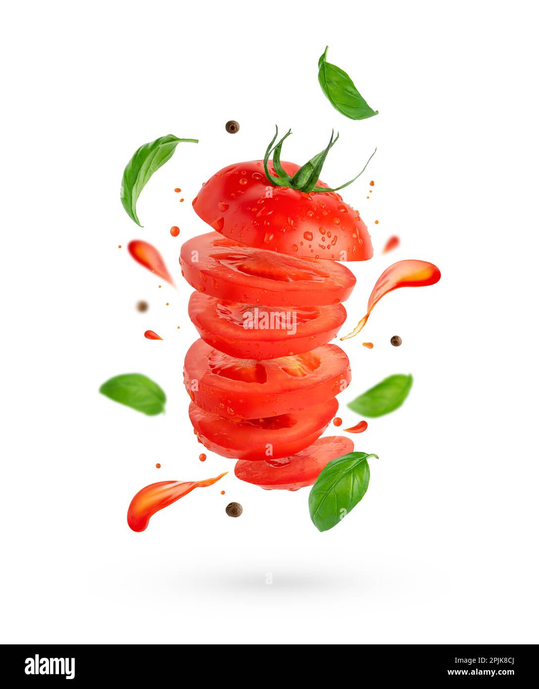 Flying sliced tomato with flowing splashes and basil leaves on white ...