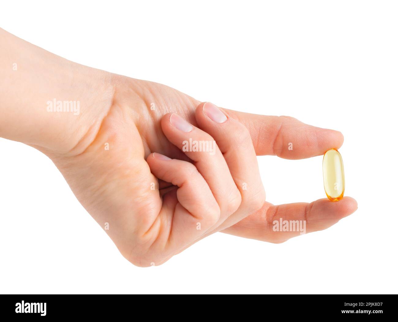 Female hand holding omega capsule isolated on white background with ...