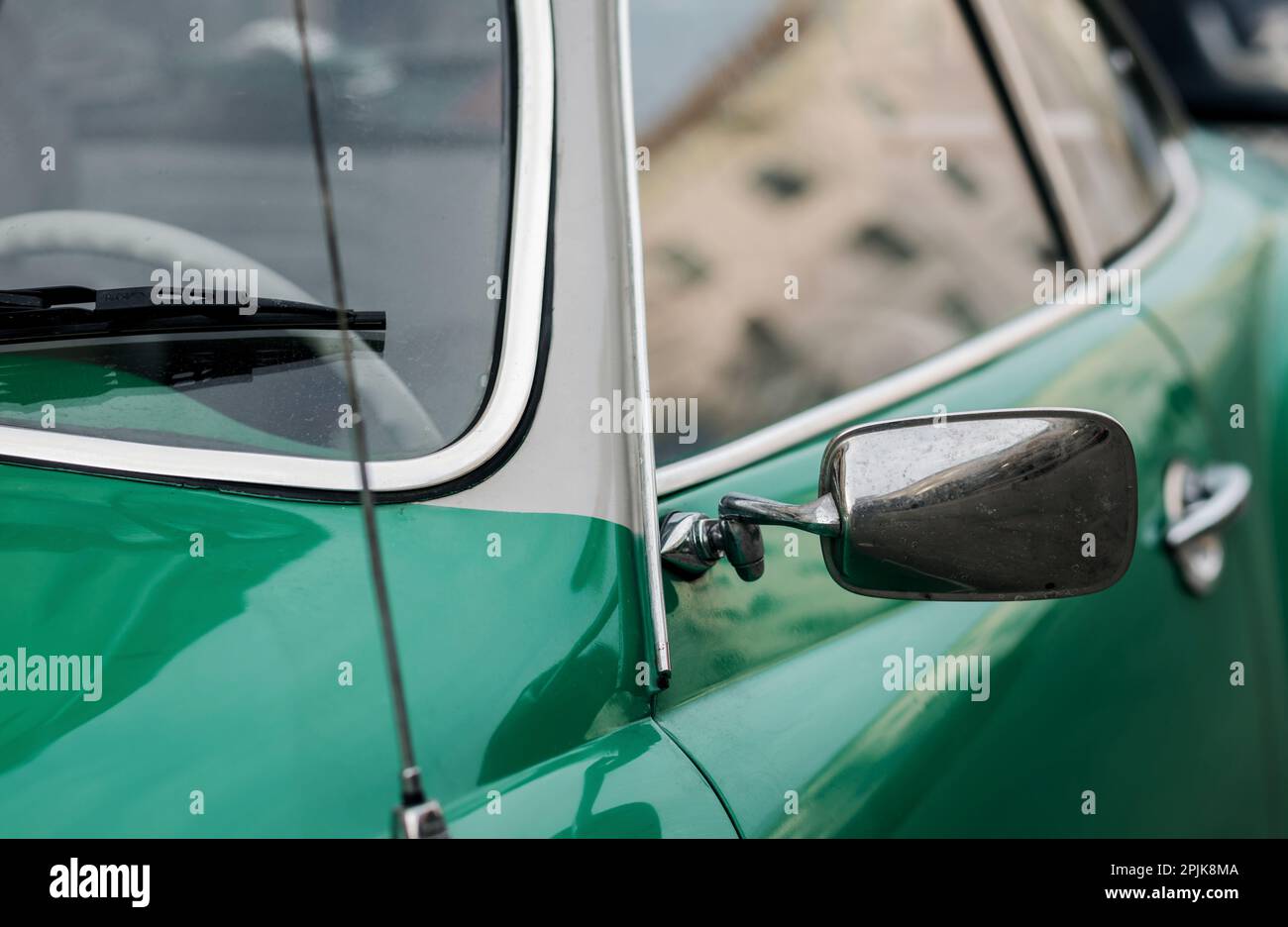 Classic car background. Close-up of the side mirror of a classic design ...