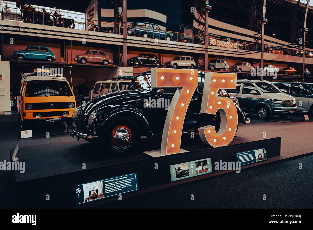 An interior showroom featuring a colorful array of cars on display for ...