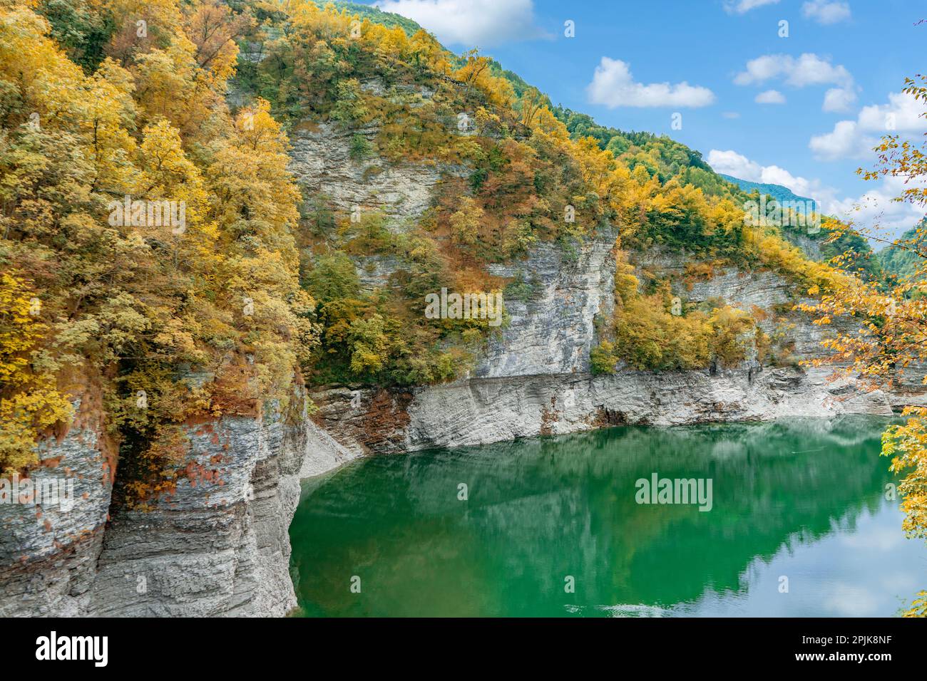 Beautiful autumn landscape of Lake Corlo in Italy surrounded by rocks ...
