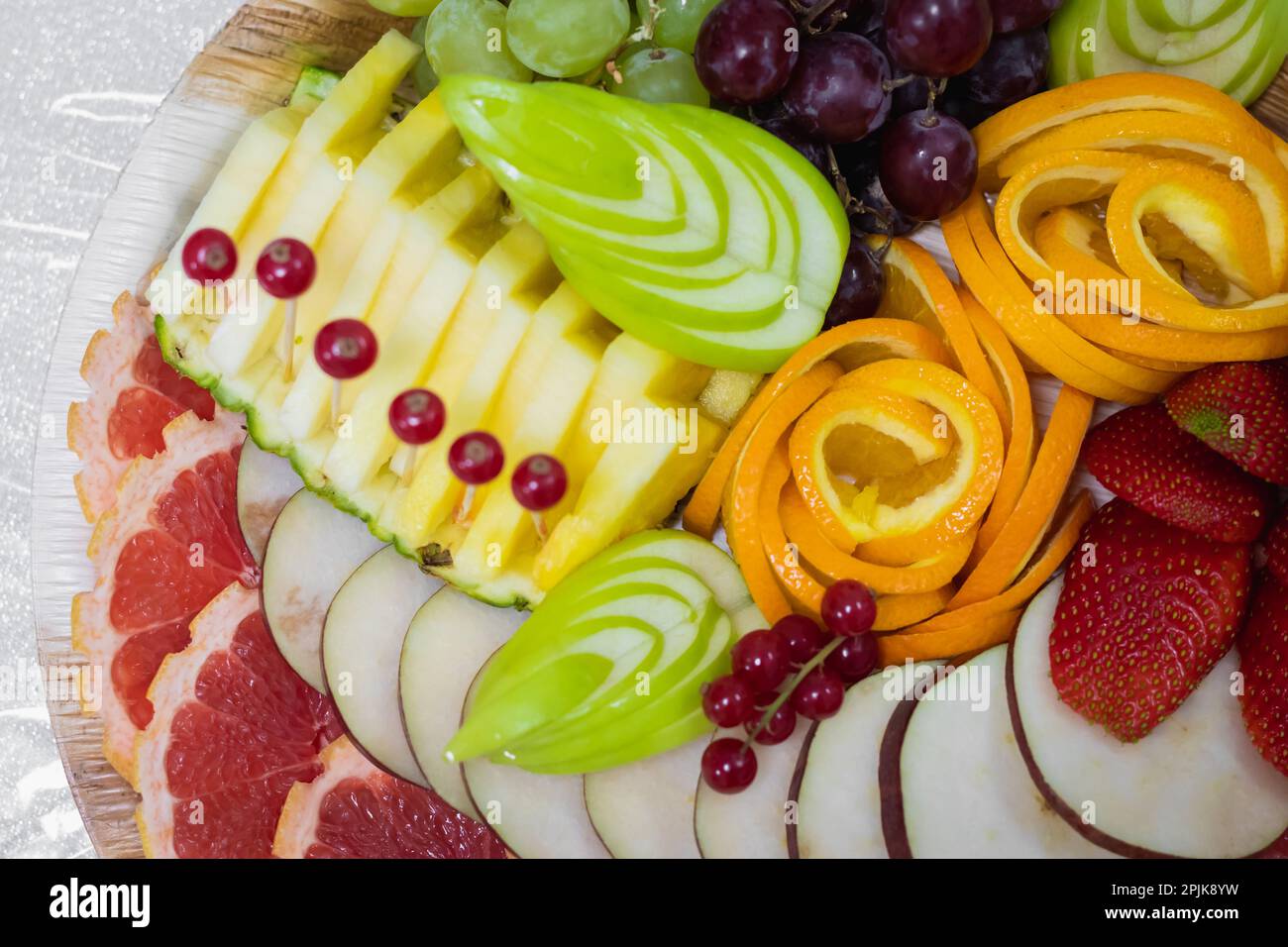 Cut fruits are arranged on a tray in an artistic way Stock Photo - Alamy