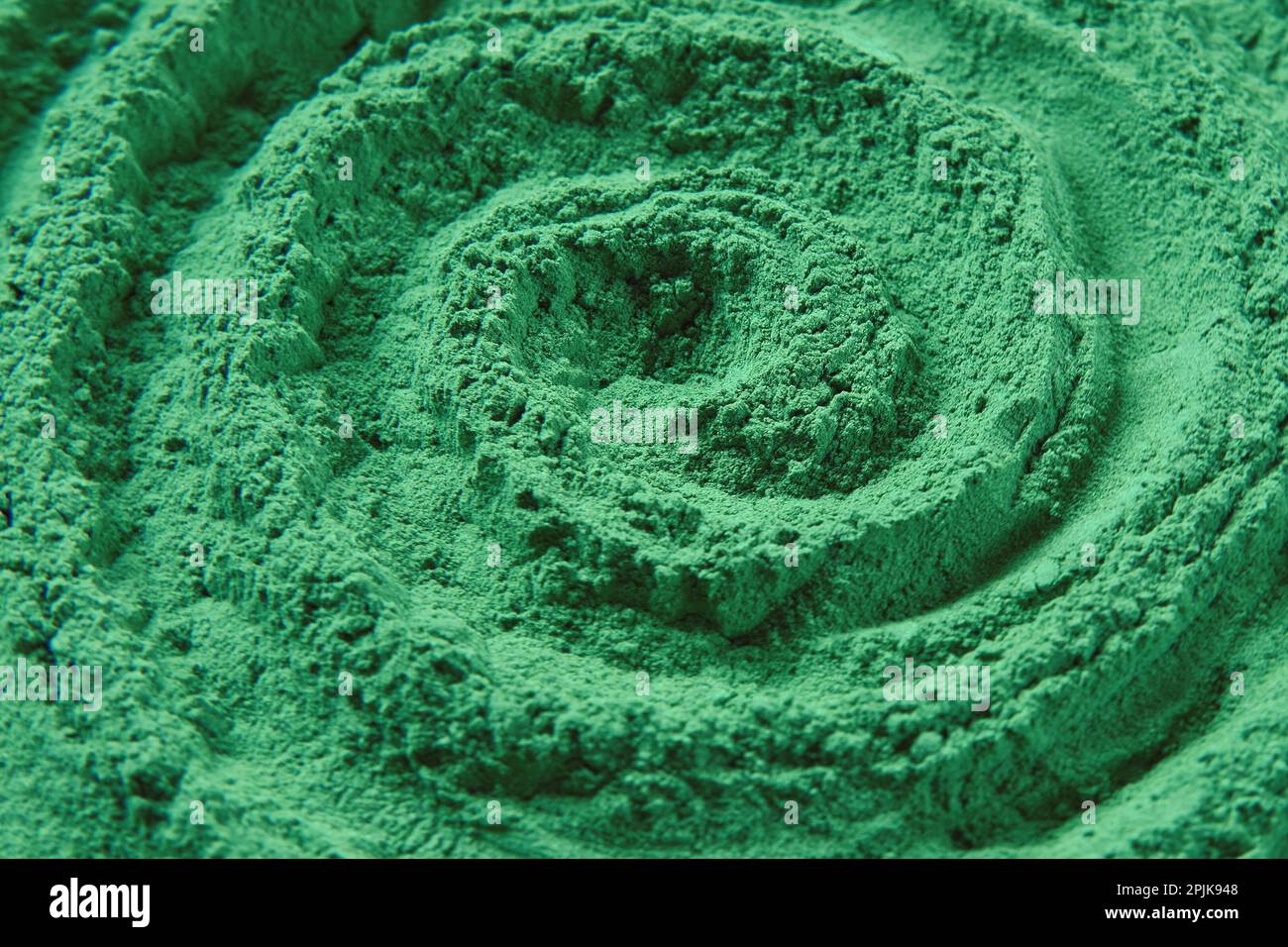 Chlorella or spirulina algae green powder is spinning, rotation ...