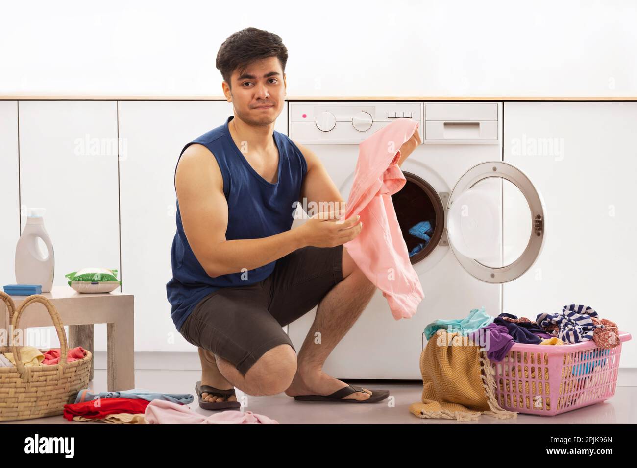 Portrait of young man with laundry hi-res stock photography and images ...