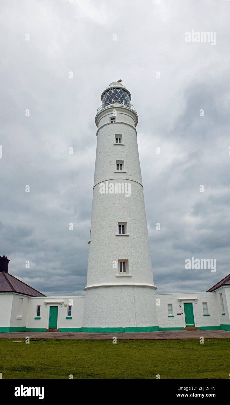 A portrait view of the Nash Point Lighthouse on the cliffs looking ...