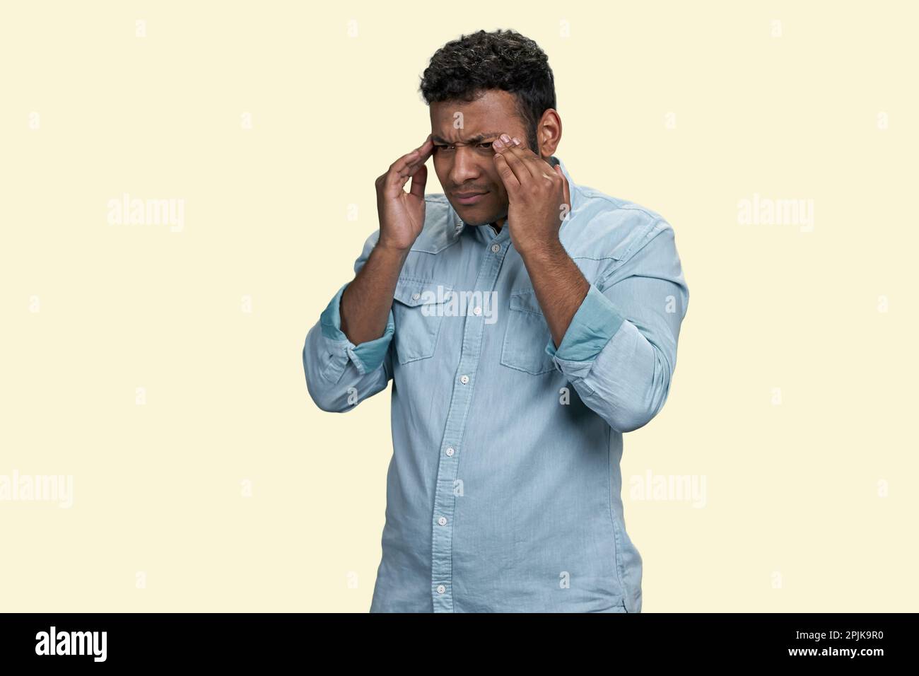 Young brown indian man touching his head because of headache or ...
