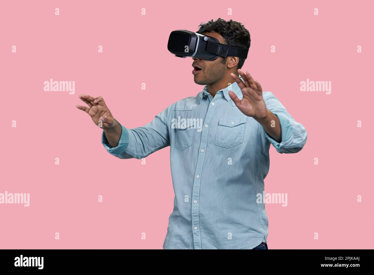 Excited indian man expreiences virtual reality. Brown southasian guy ...