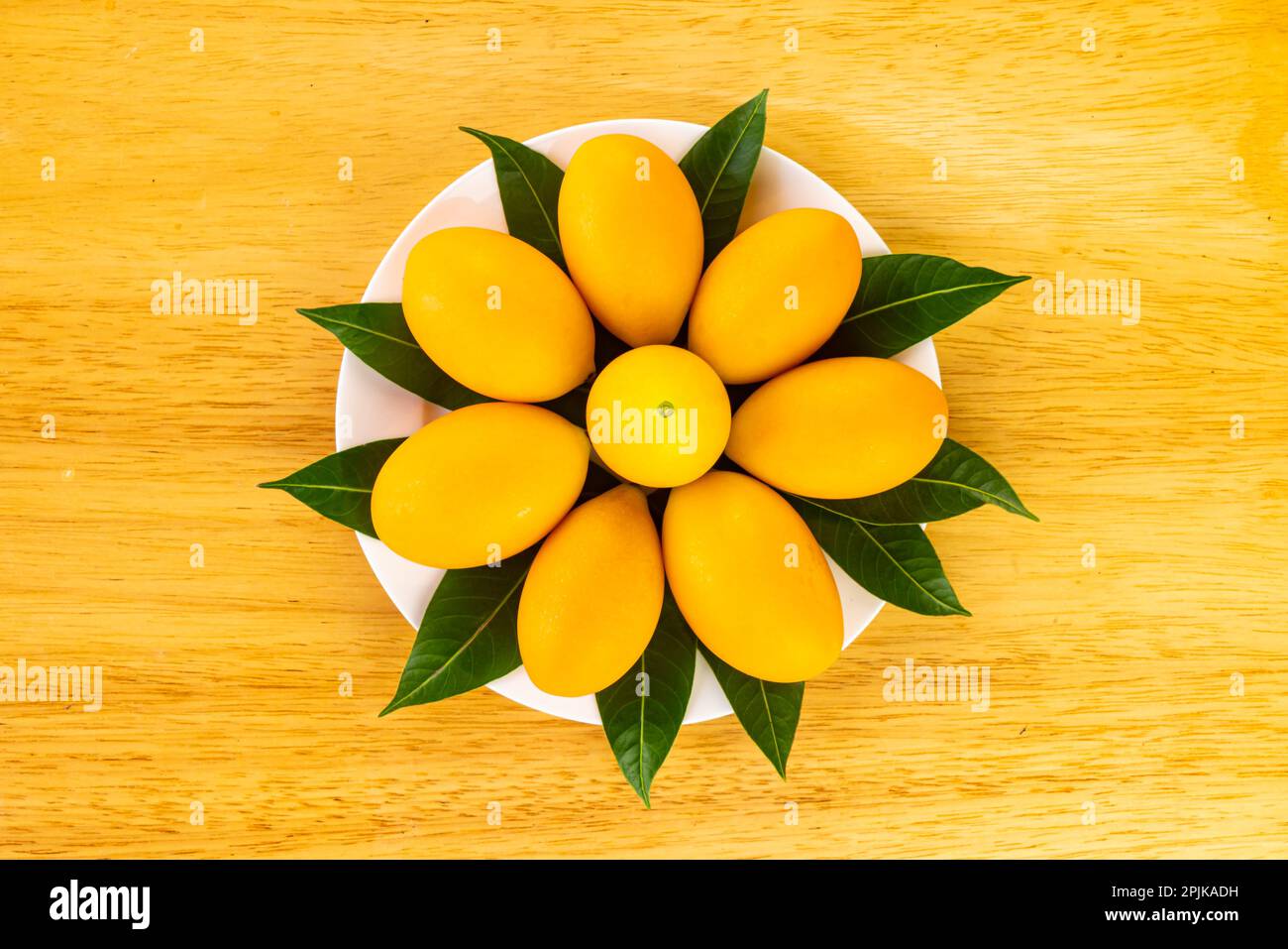 Top view of ripe sweet yellow marian plum or Bouea macrophylla griffith ...