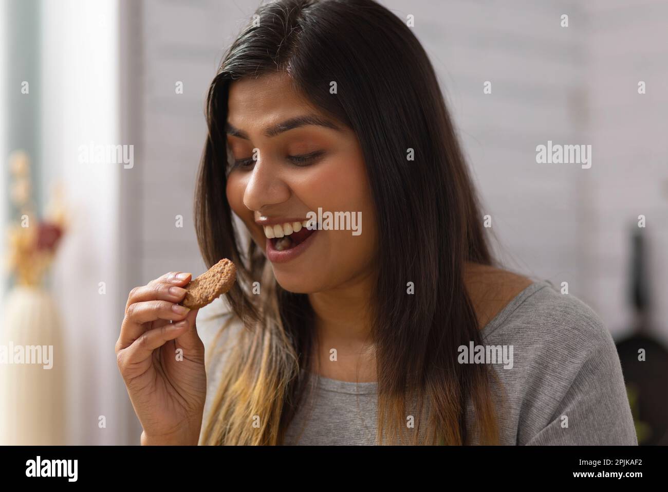 Woman eating cookies hi-res stock photography and images - Alamy
