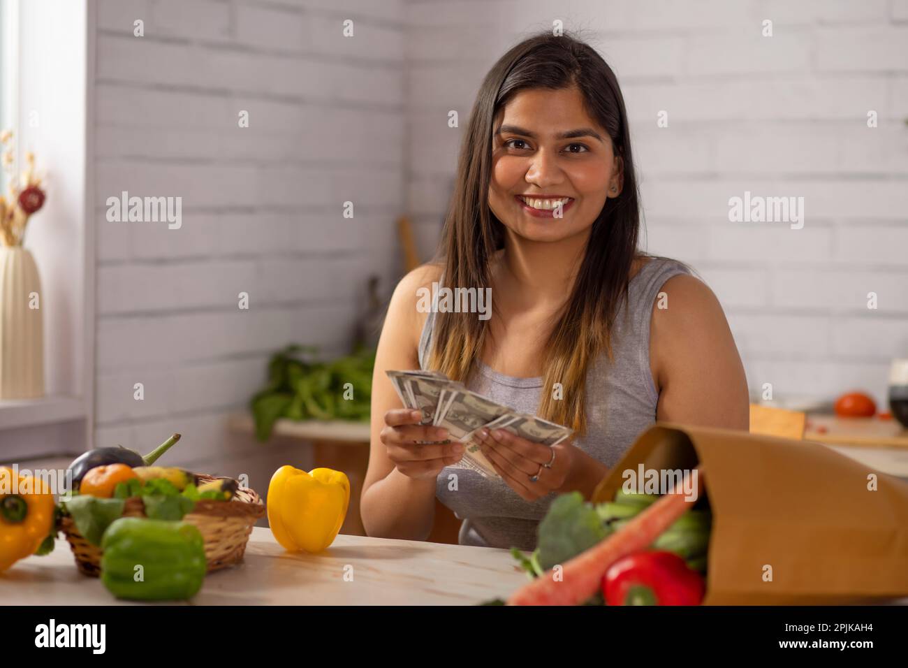 Indian woman counting money hi-res stock photography and images - Alamy