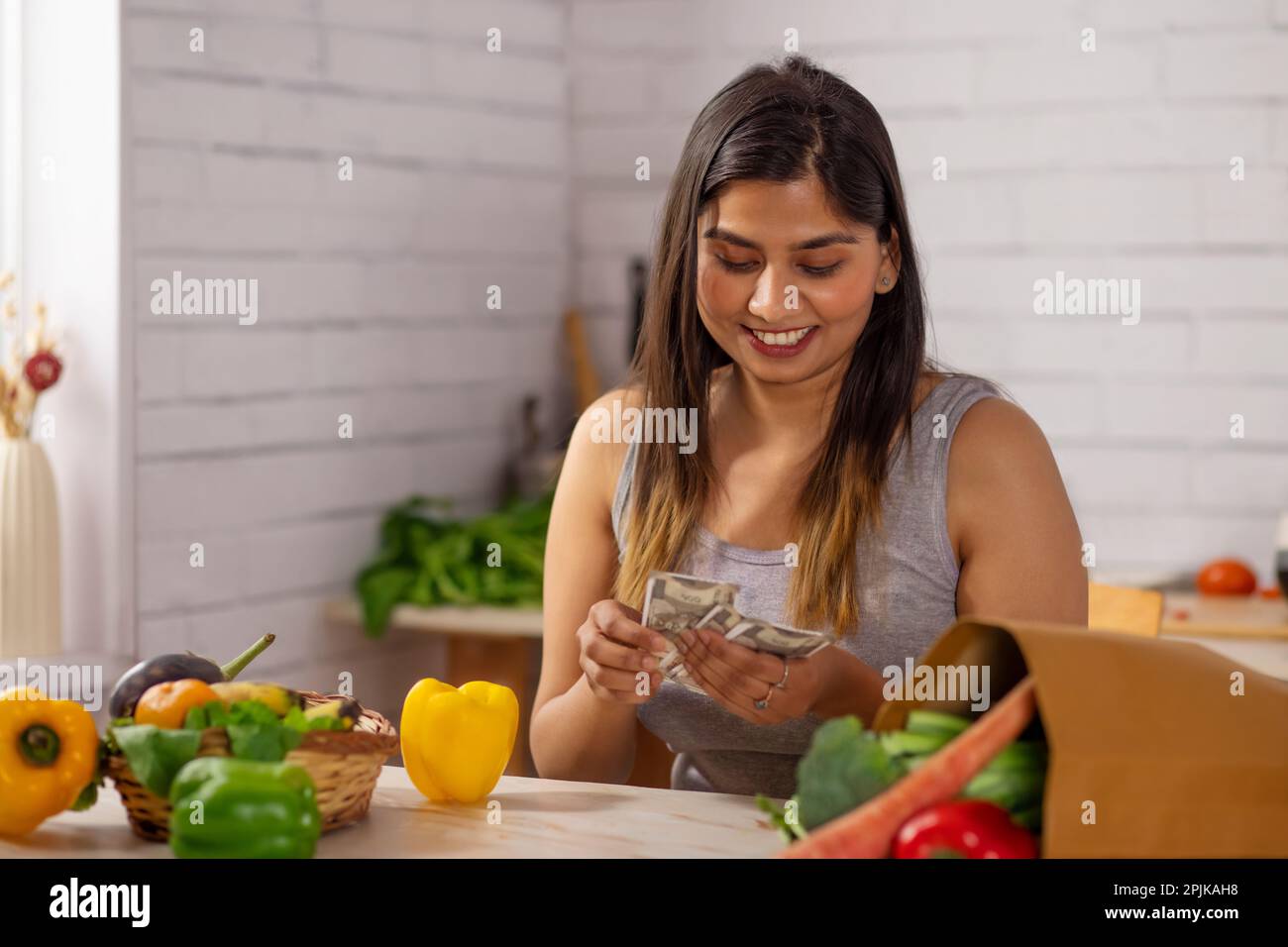 Indian woman counting money hi-res stock photography and images - Alamy