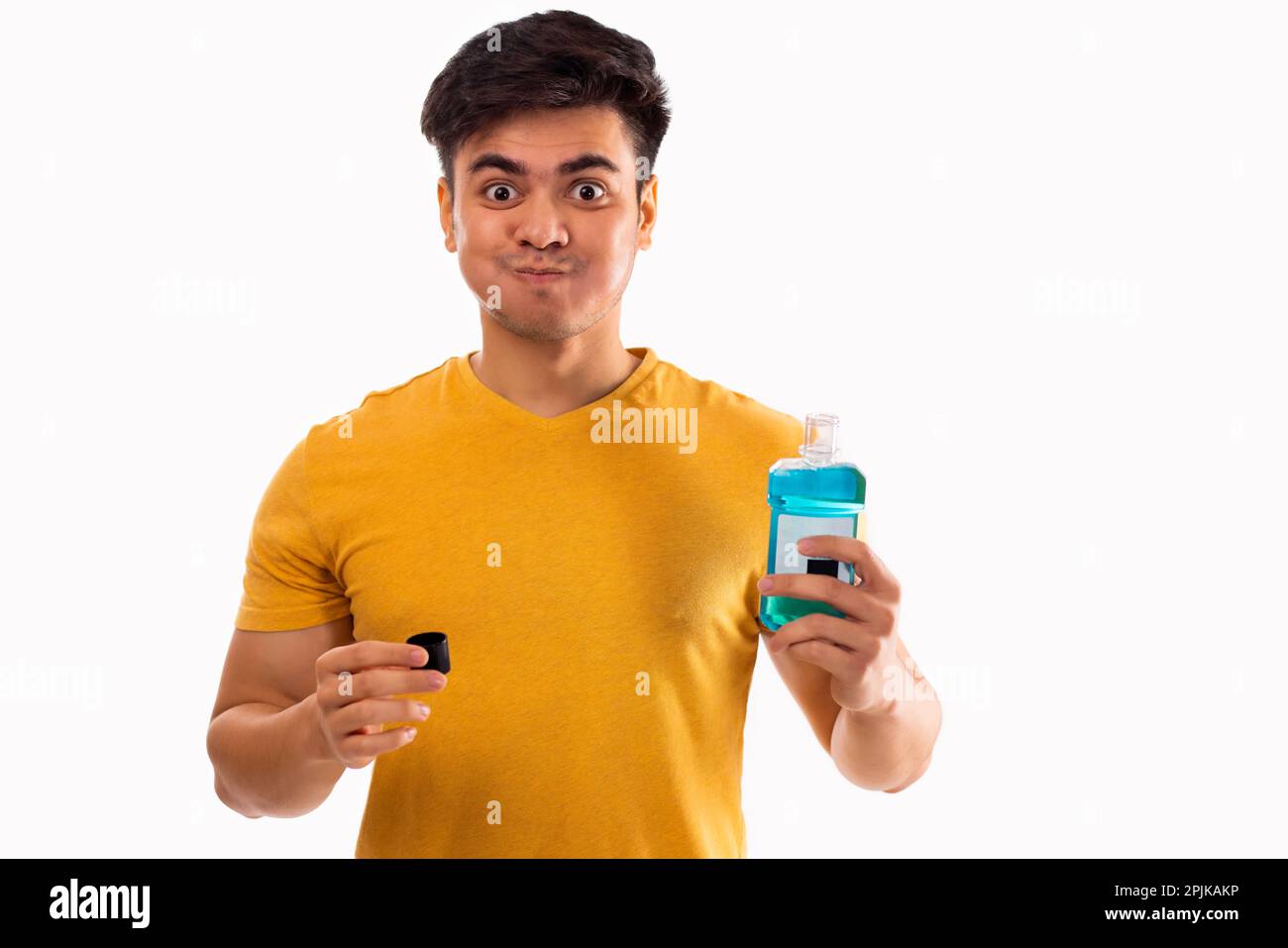 Young man rinsing mouth with mouthwash Stock Photo - Alamy