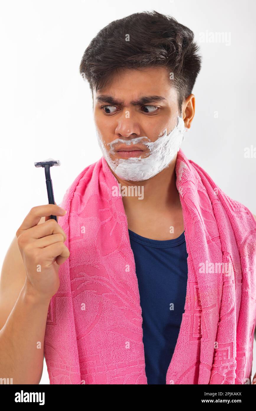 Man holding bath towel hi-res stock photography and images - Alamy