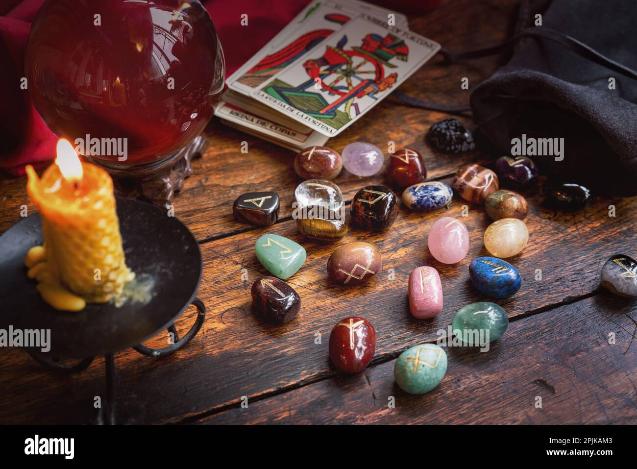 Runestones on red napkin. Divination items. Runes, crystal ball ...