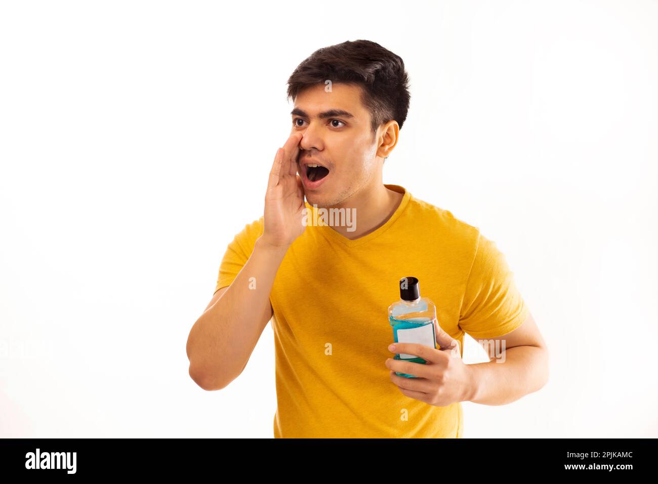 Young man smelling his breath after using mouthwash Stock Photo - Alamy