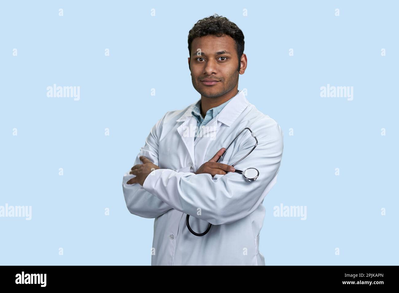 Smiling male indian doctor wearing medical coat and stethoscope ...