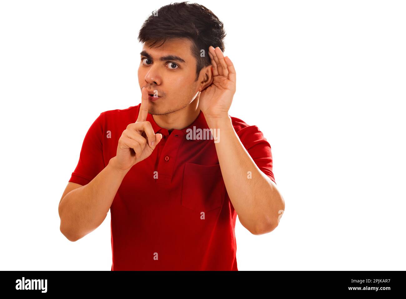 Portrait of young man showing hush gesture against white background ...