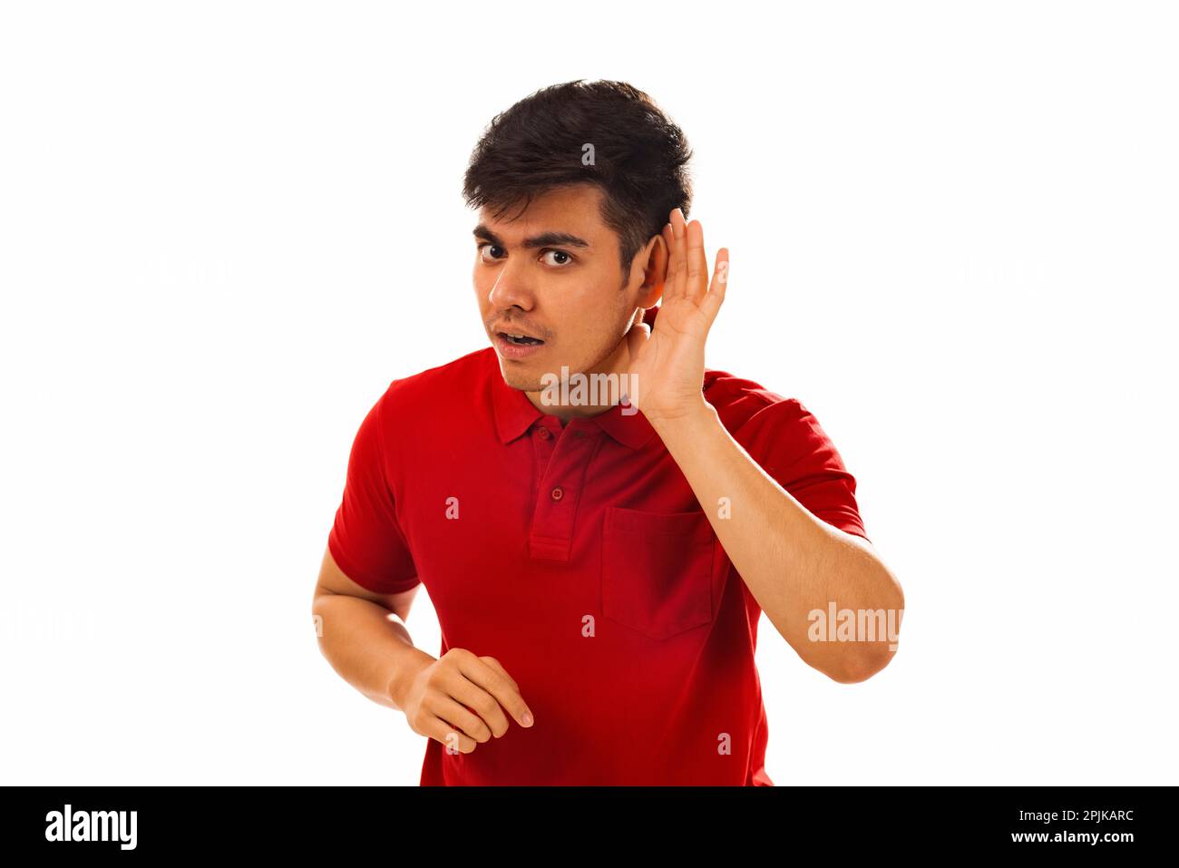 Portrait of young man holding his hand behind ear Stock Photo - Alamy
