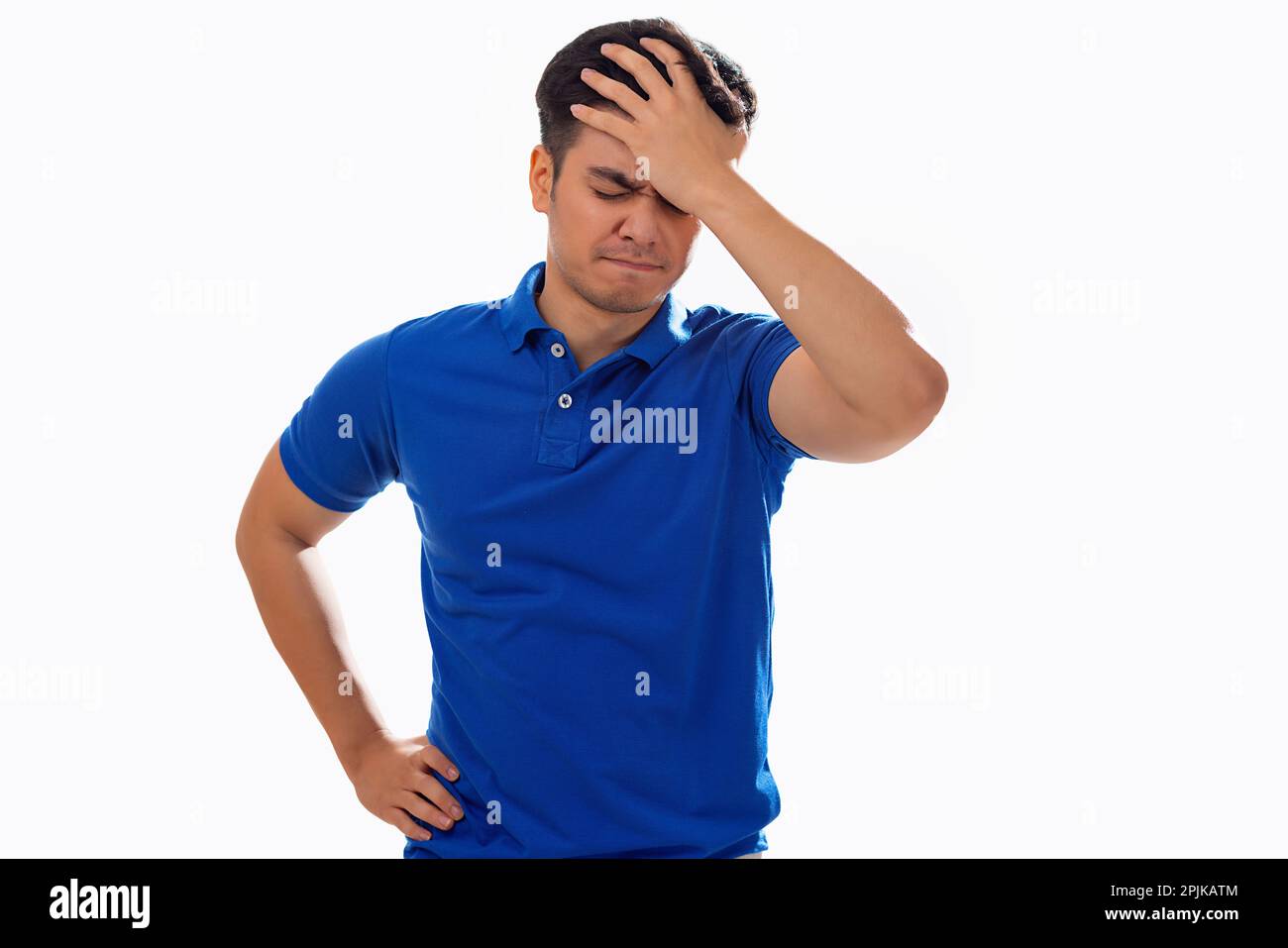 Portrait of sad young man with hand on head against white background ...