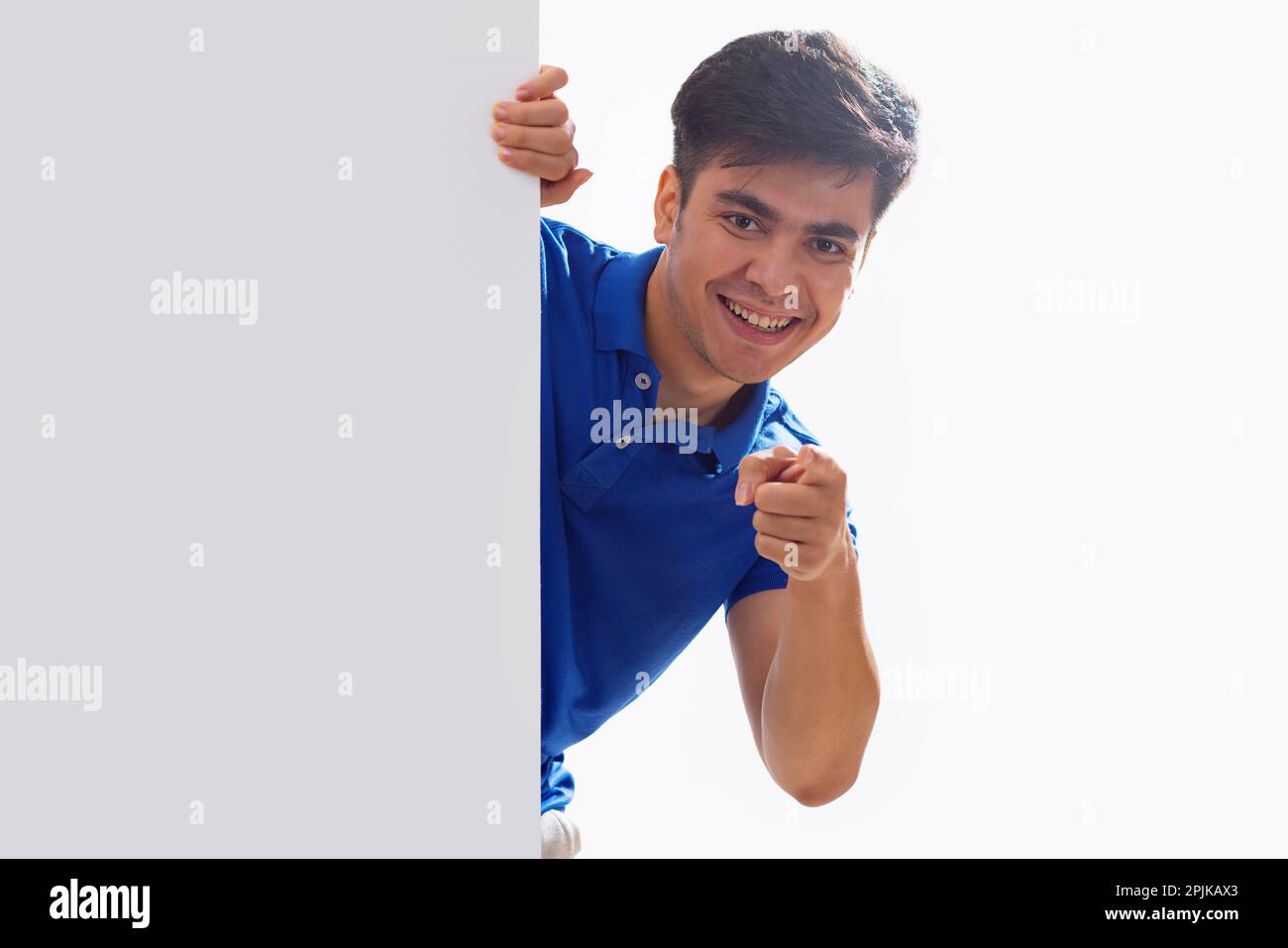 Smiling young man peeking hi-res stock photography and images - Alamy