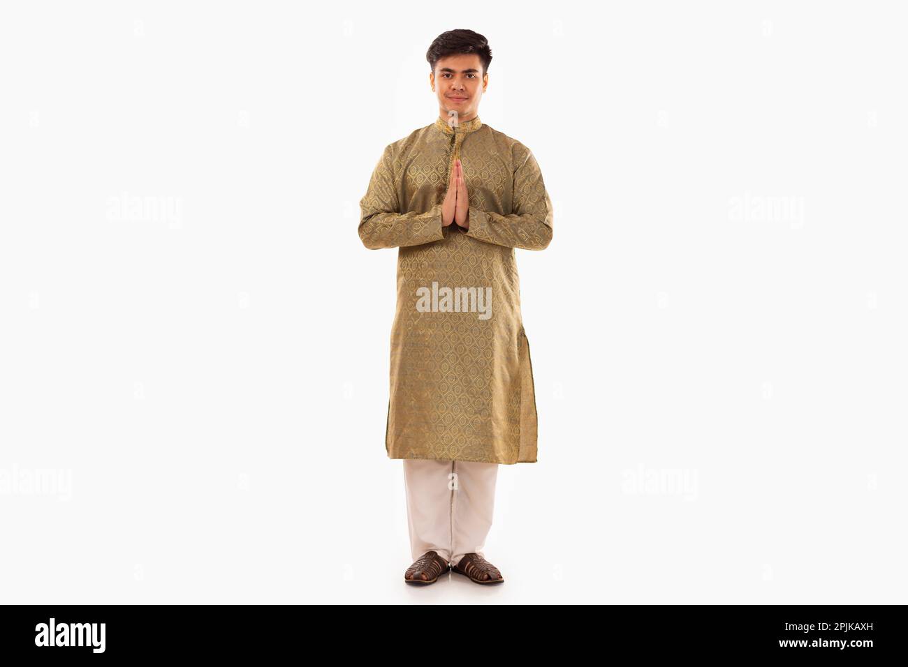 Portrait of young man greeting against white background Stock Photo - Alamy