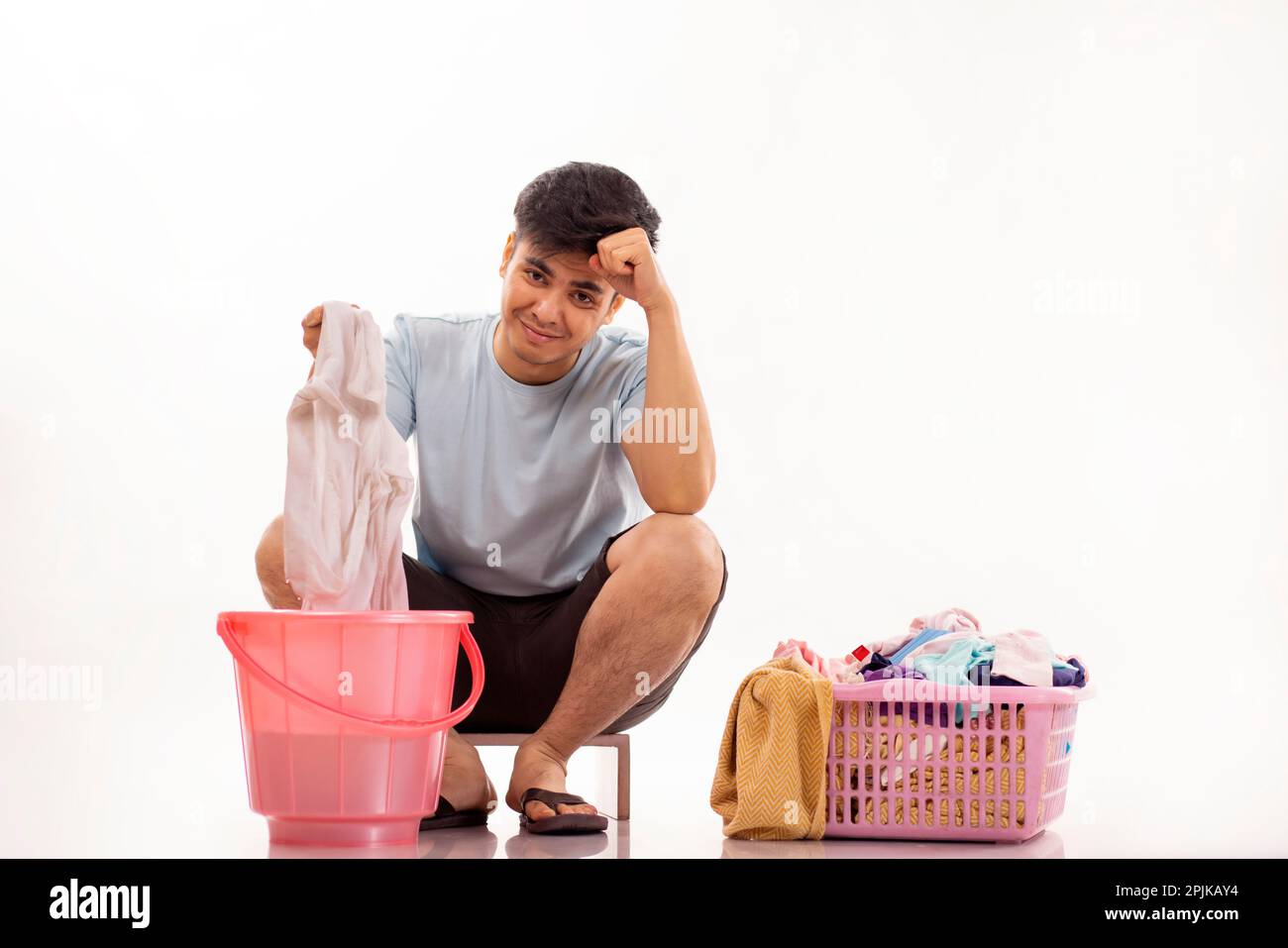 Portrait of young man washing clothes by hand Stock Photo - Alamy