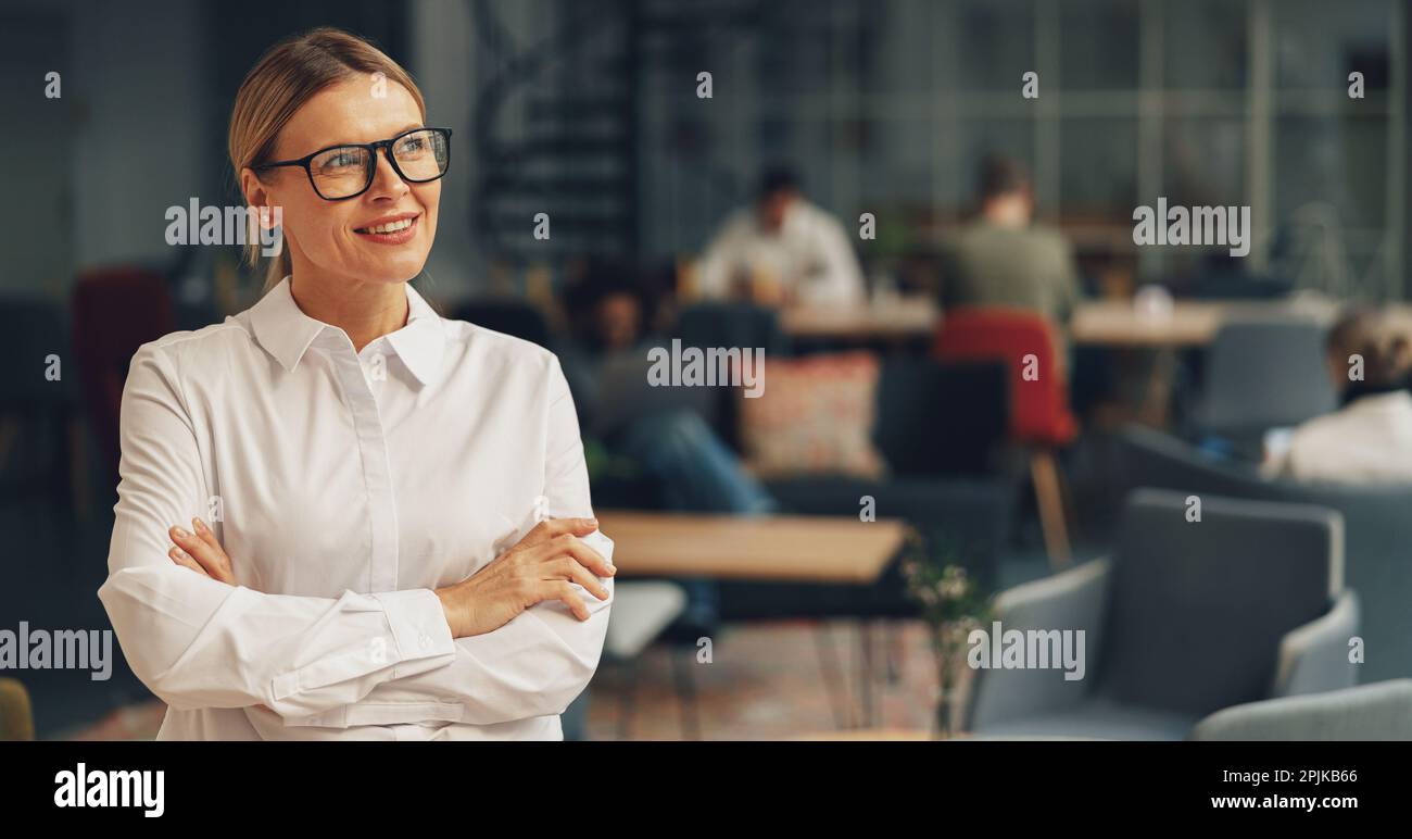 Portrait of successful woman manager standing with crossing hands in ...