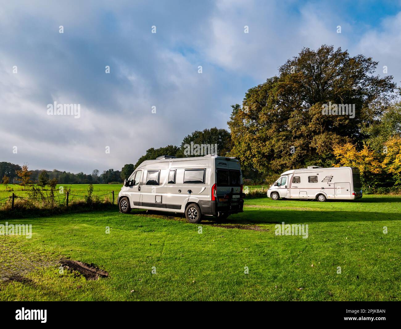 Motorhomes parked on grass of touring caravan park with view over ...