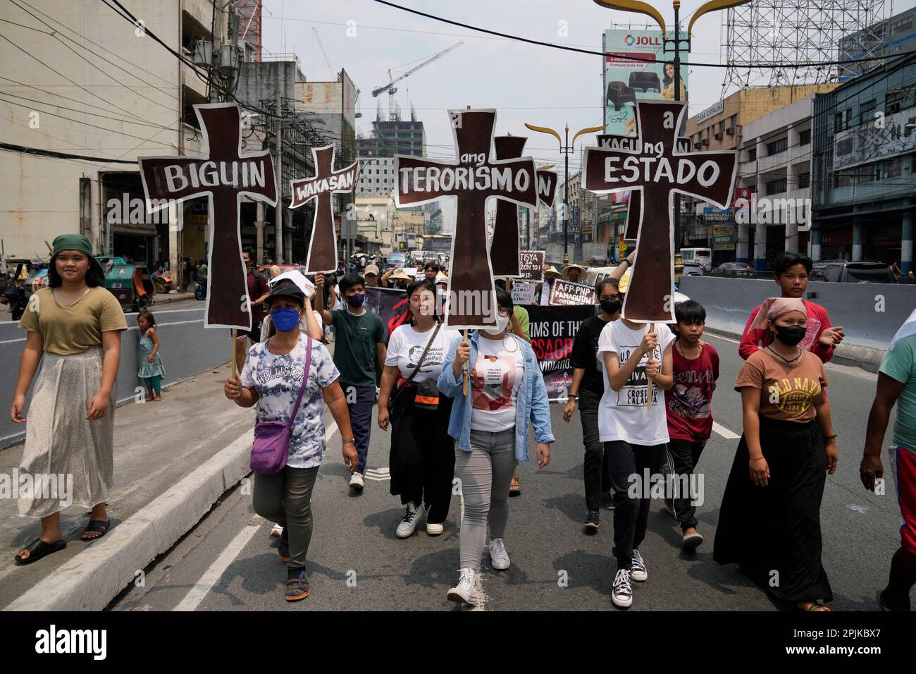 Activists carry crosses as they reenact the sufferings of Jesus Christ ...