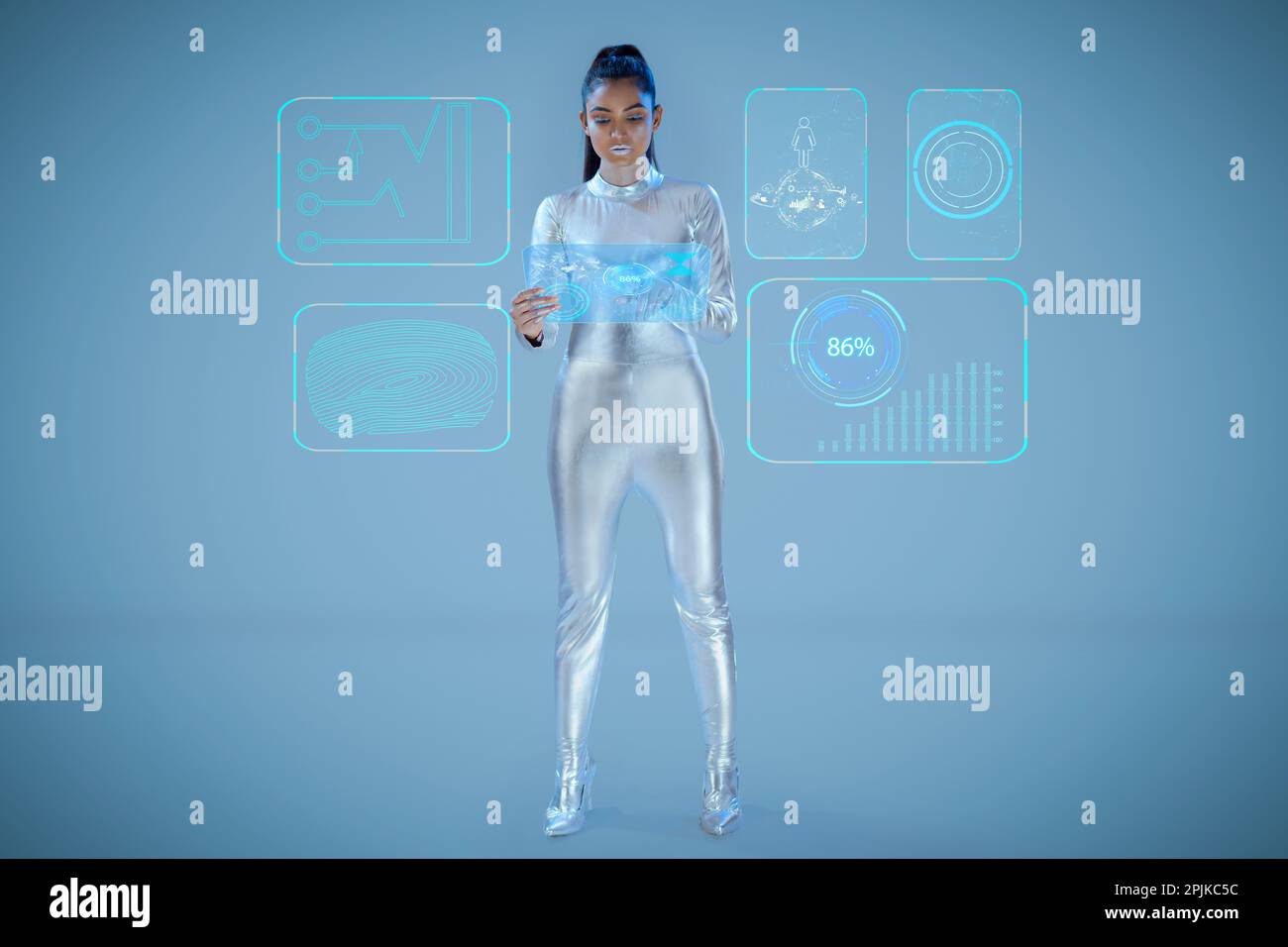 A model dressed as a robot wearing silver, futuristic clothes holding a ...