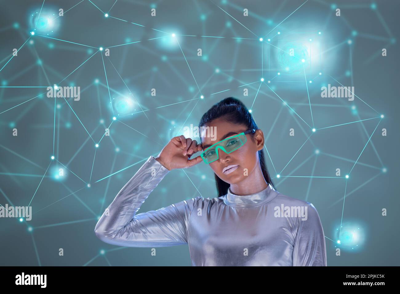 A model dressed as a robot wearing silver clothes and digital glasses ...