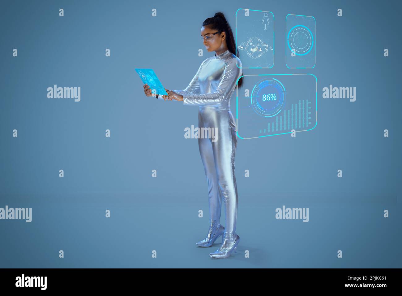 A model dressed as a robot wearing silver, futuristic clothes holding a ...