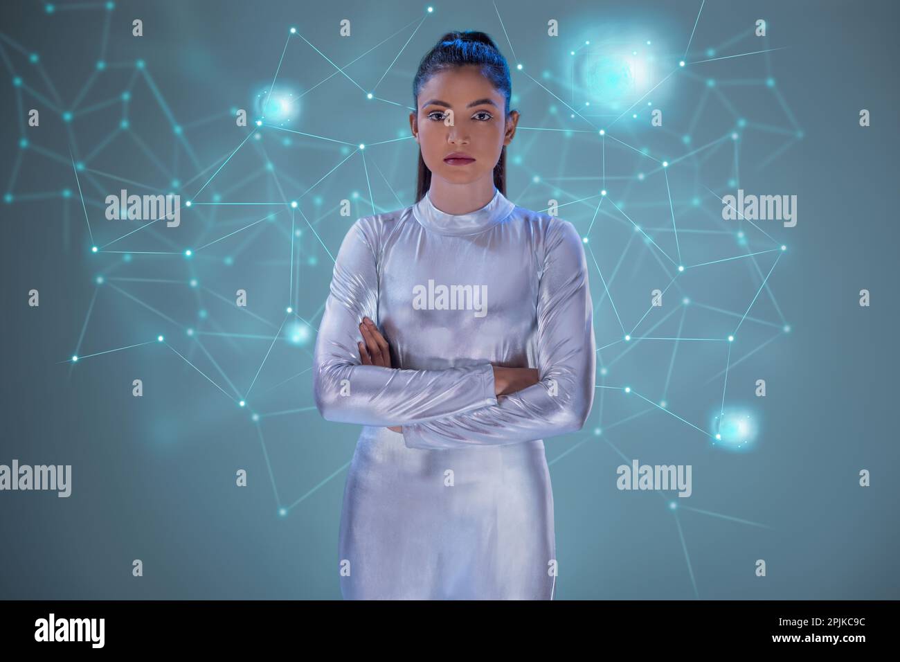 A woman wearing silver futuristic clothes with virtual icons in the ...