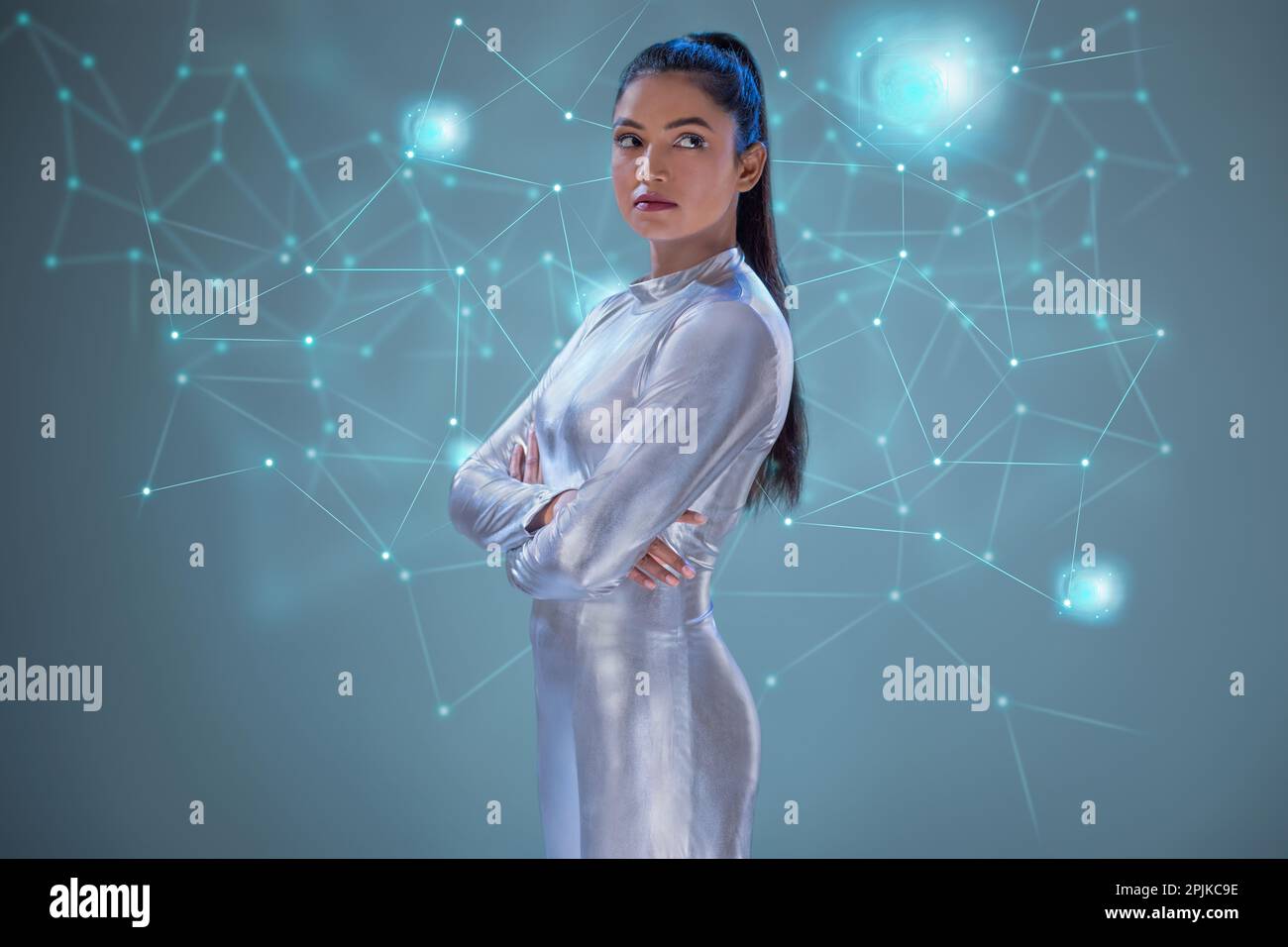 A woman wearing silver futuristic clothes with virtual icons in the ...