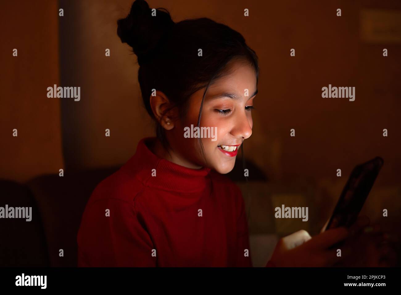 Close-up portrait of a tween girl using mobile phone Stock Photo - Alamy