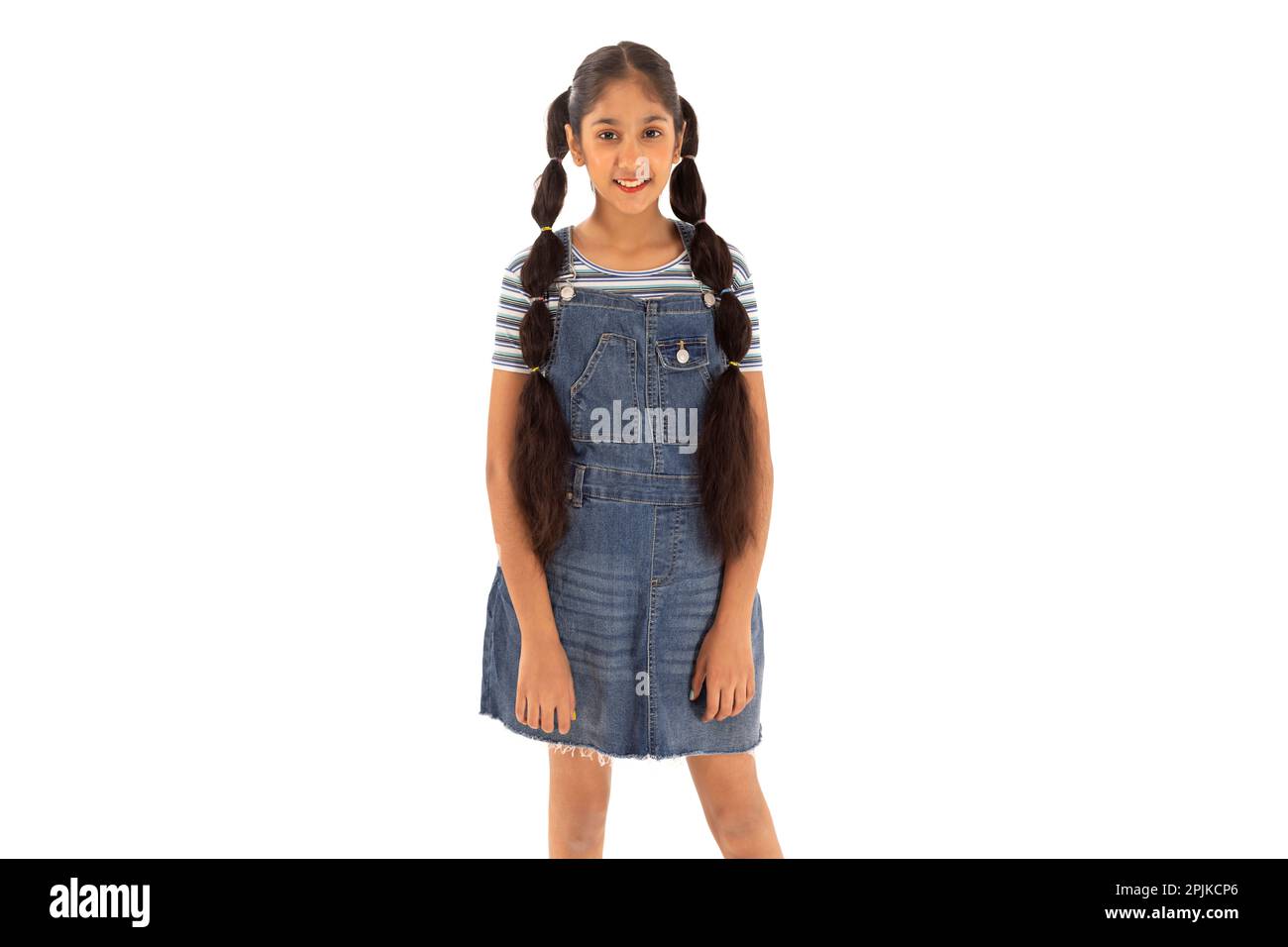 Tween girl with braided hair standing against white background Stock ...