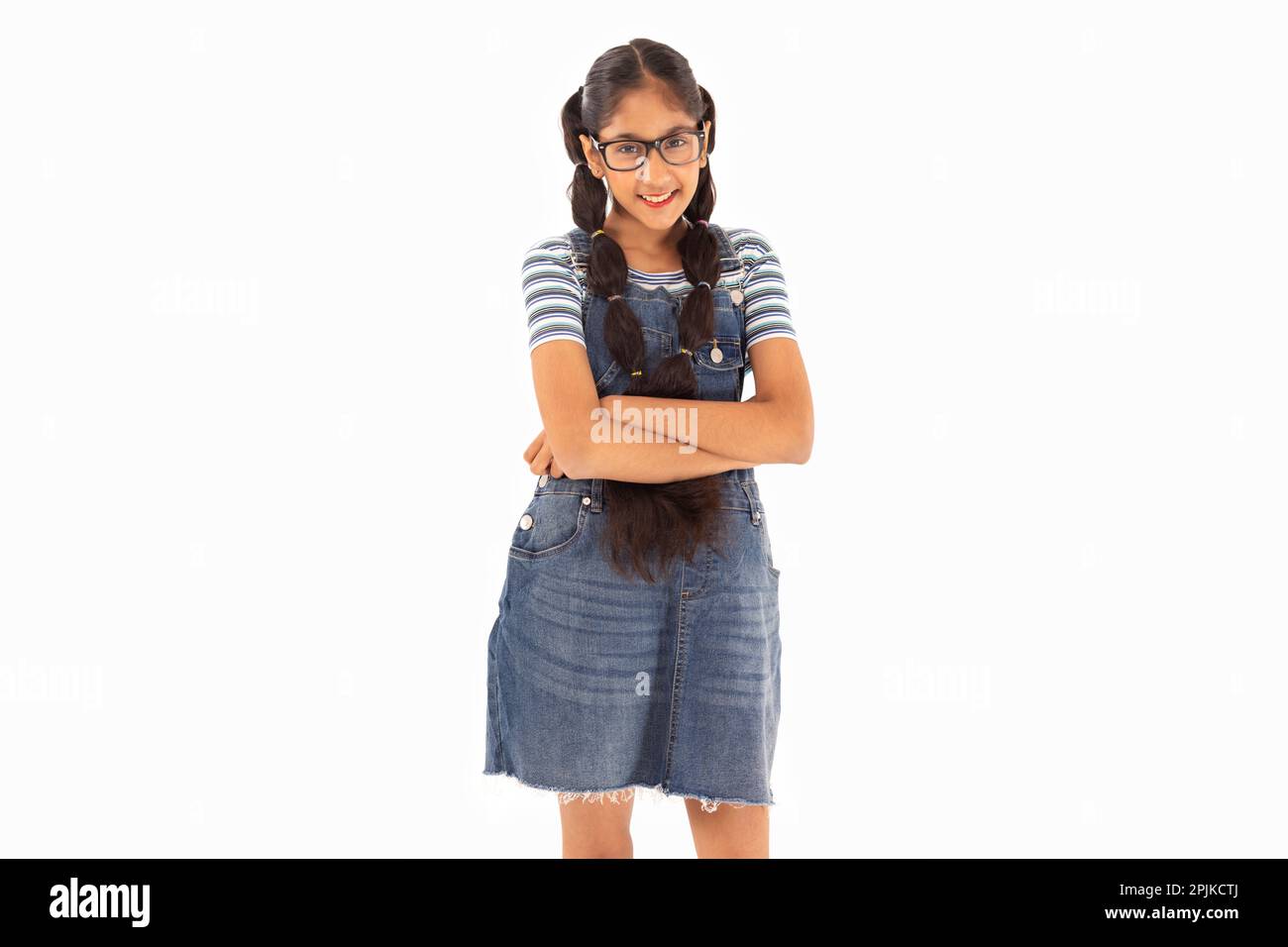 Tween girl with braided hair standing against white background Stock ...