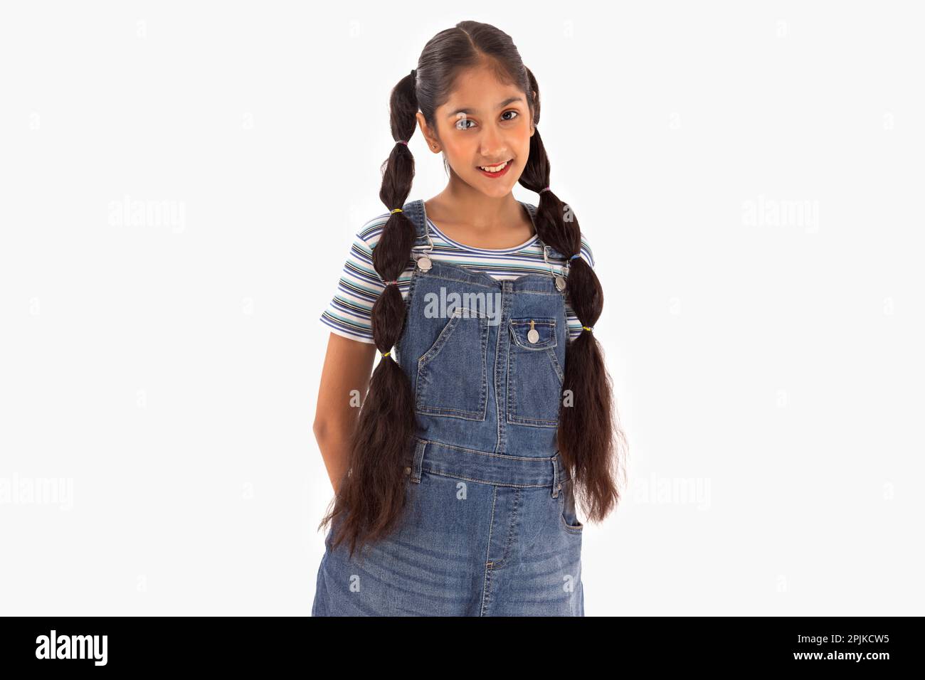 Tween girl with braided hair standing against white background Stock ...