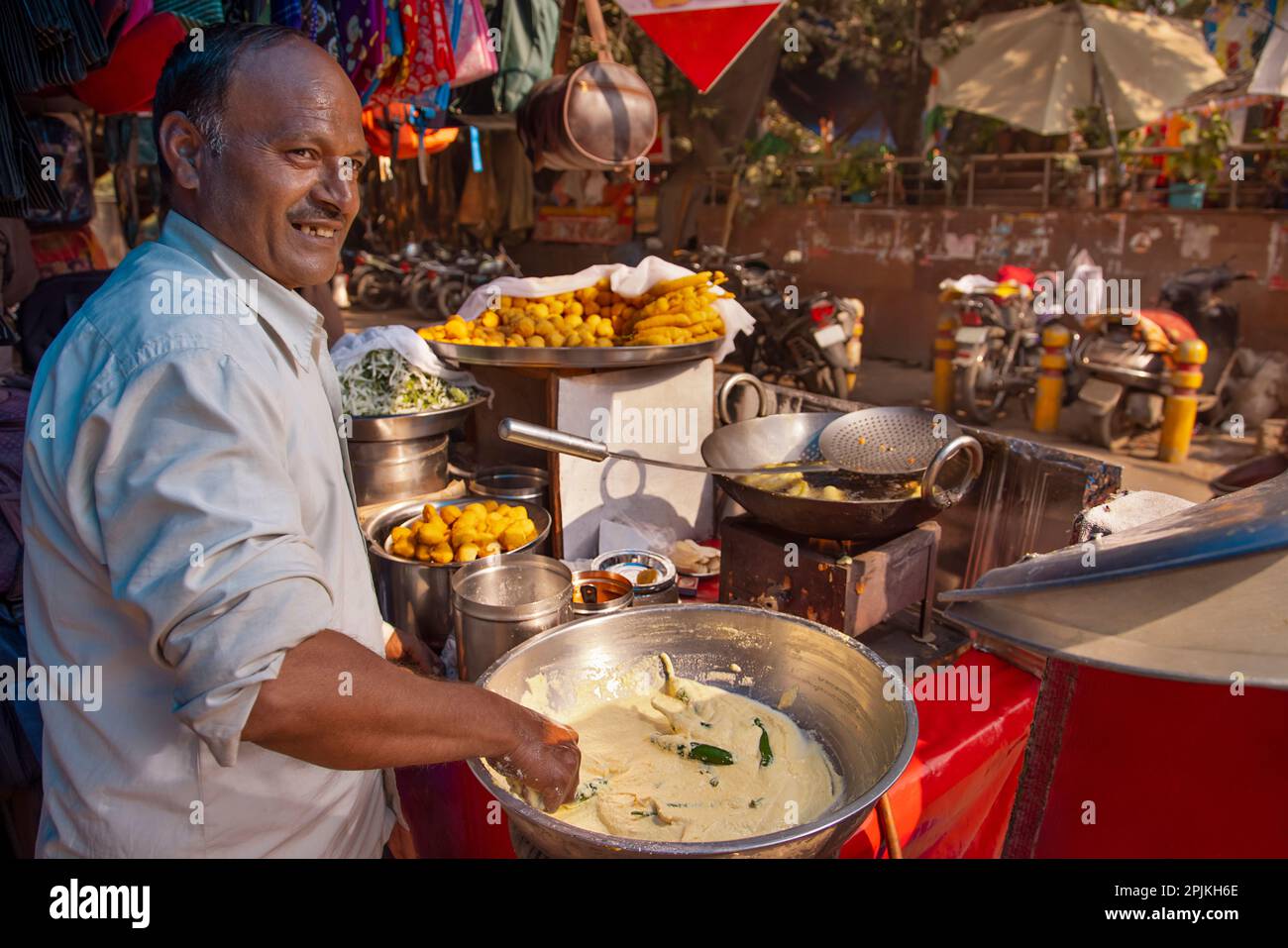Male vendor making Mirchi Bajji at his roadside food stall Stock Photo ...