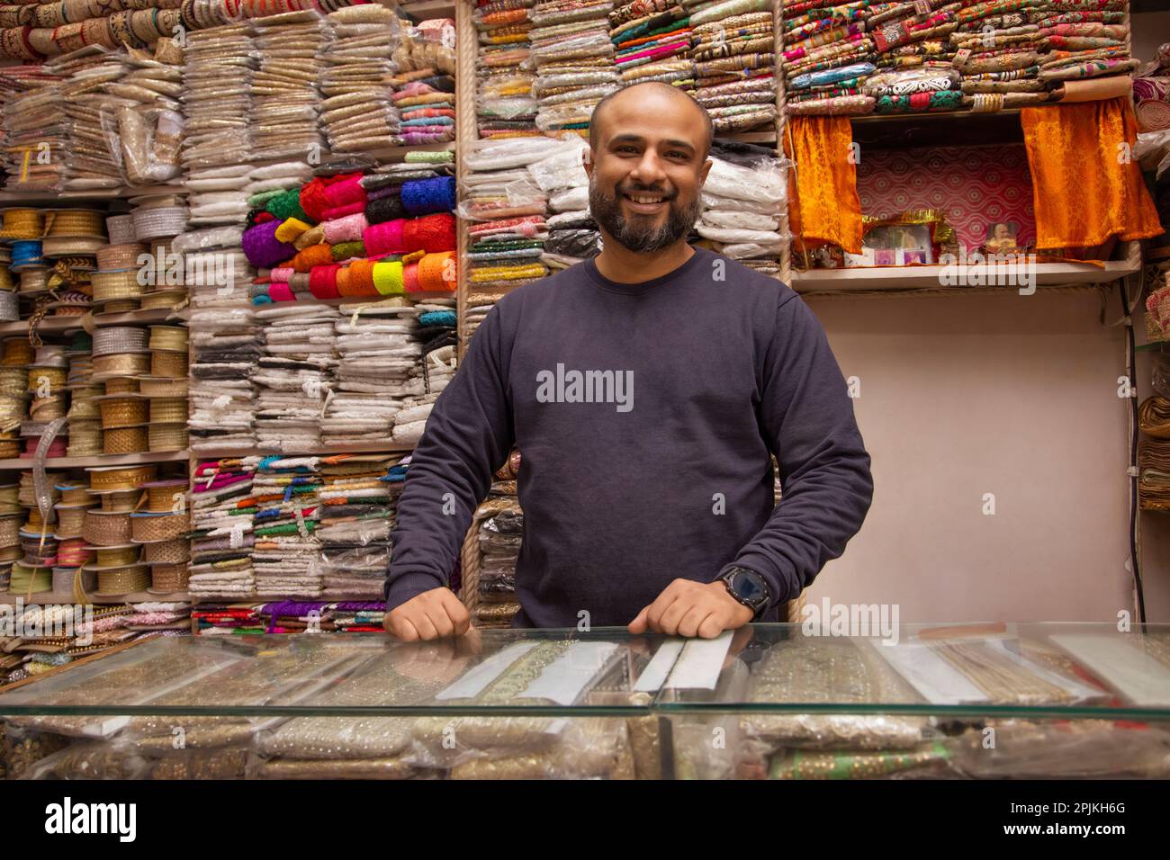 Portrait of a cheerful male shop keeper standing at his lace shop Stock ...